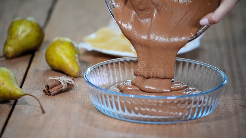 Female Chef Hands Pouring Batter into Baking Dish. Making Chocolate Pie ...