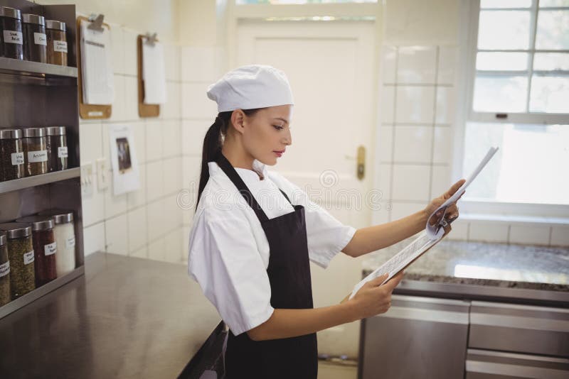 Chef Looking at an Order List in the Commercial Kitchen Stock Photo ...