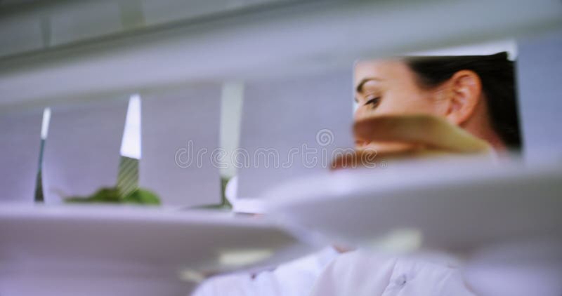 Female Chef Looking at an Order List in the Commercial Kitchen 4k Stock ...