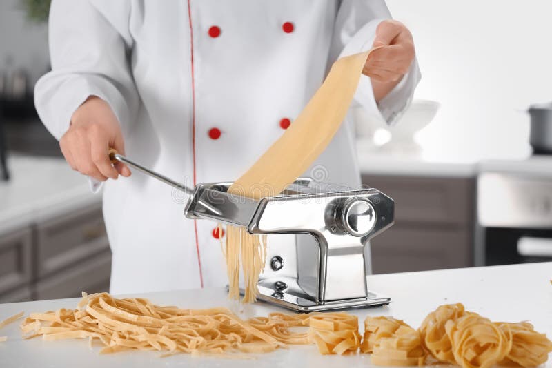 Female Chef Making Noodles with Pasta Machine at Table Stock Image ...