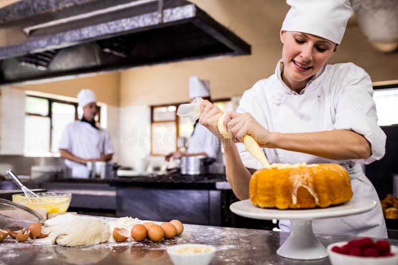 Female Chef Piping a Cake in Kitchen Stock Image - Image of standing ...