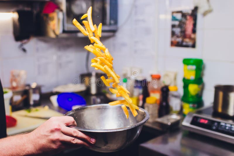 Female Chef Preparing French Fries in Kitchen. Stock Image - Image of ...