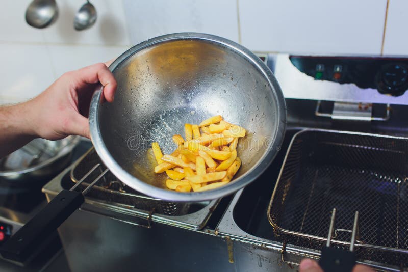 Female Chef Preparing French Fries in Kitchen. Stock Photo - Image of ...