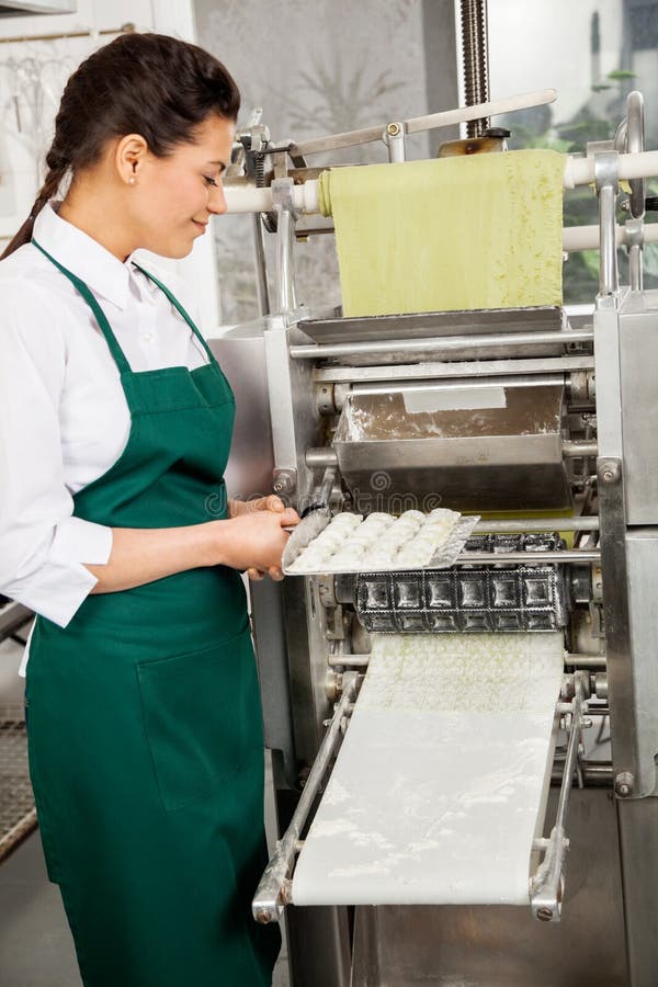 Female Chef Preparing Ravioli Pasta in Machine Stock Photo - Image of ...
