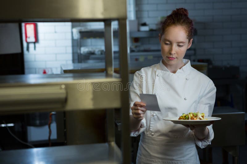 Chef Reading His Order on Sticky Note in Kitchen Counter Stock Photo ...
