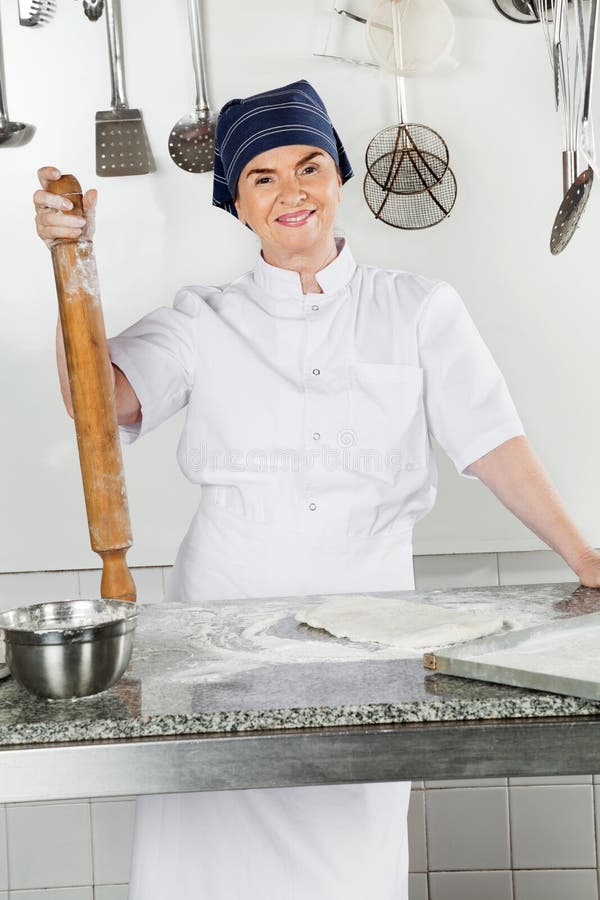 Female Chef with Rolling Pin by Kitchen Counter Stock Photo - Image of ...
