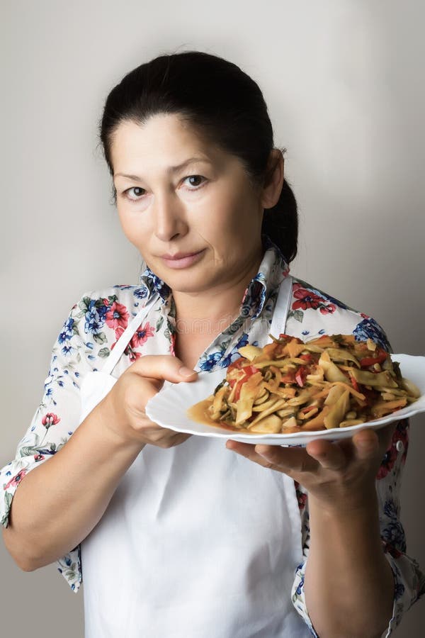Female Chef Shows Dish of Yellow Beans Stock Photo - Image of garlic ...