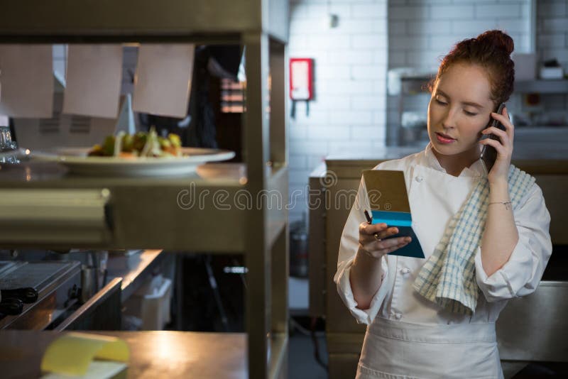 Female Chef Taking an Order on the Phone Stock Photo - Image of ...