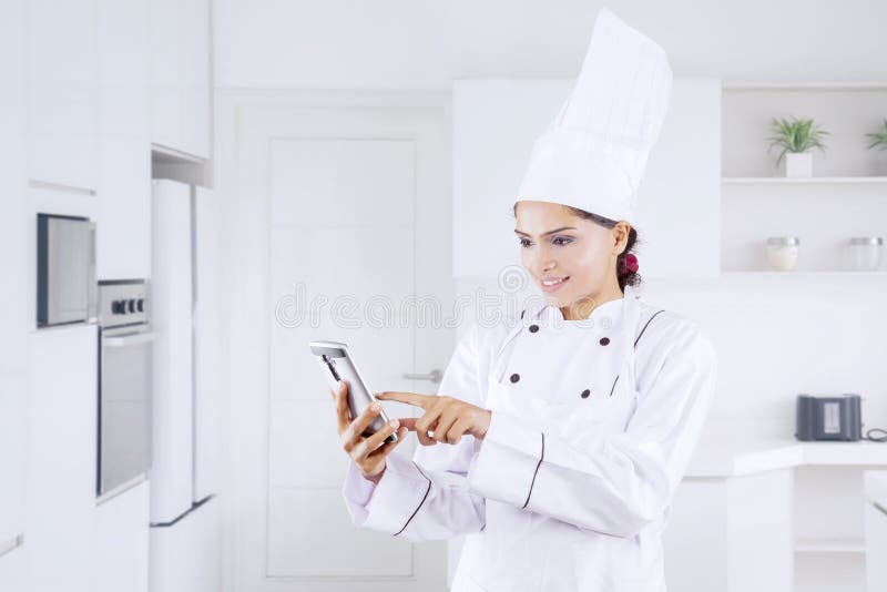 Female Chef Using a Phone in the Kitchen Stock Photo - Image of ...