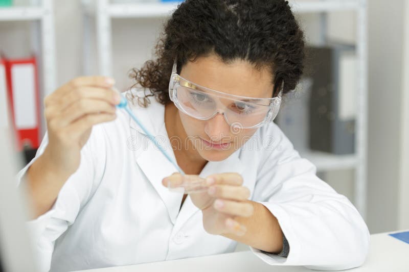 Female Chemist Holding Flask Stock Photo - Image of closeup, flask ...