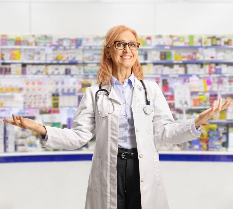 Female Chemist Smiling and Gesturing with Hands in a Pharmacy Stock ...
