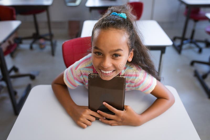 Female Child Leaning Forward on White Desk in Elementary Classroom with ...