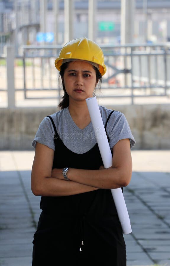 Female Civil Engineer or Architect with Yellow Helmet, Standing with ...