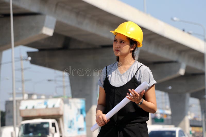 Female Civil Engineer or Architect with Yellow Helmet, Standing with ...