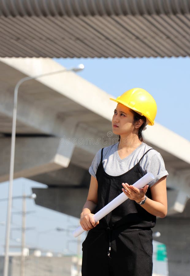 Female Civil Engineer or Architect with Yellow Helmet, Standing and ...