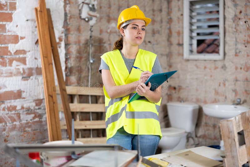 Female Civil Engineer Making Notes while Controlling Construction Site ...