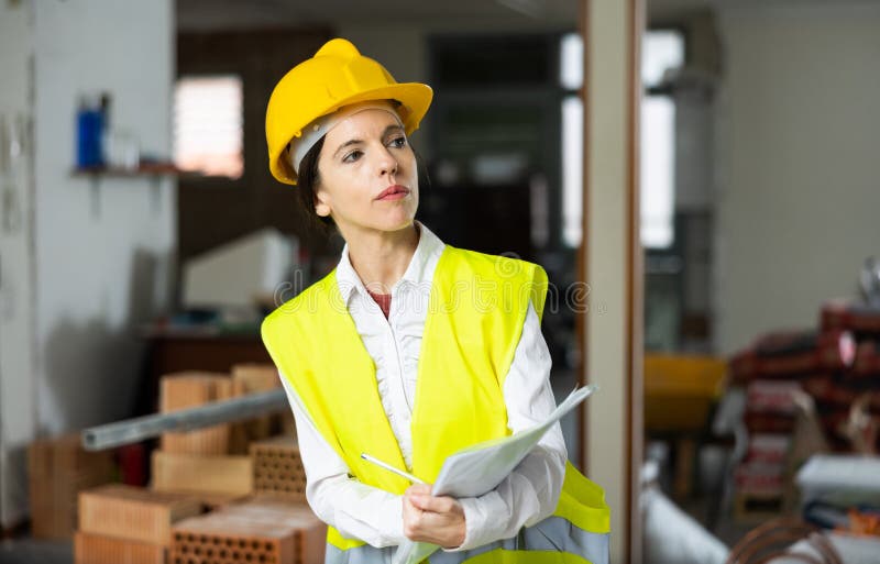 Female Civil Engineer Making Notes while Controlling Workflow at ...