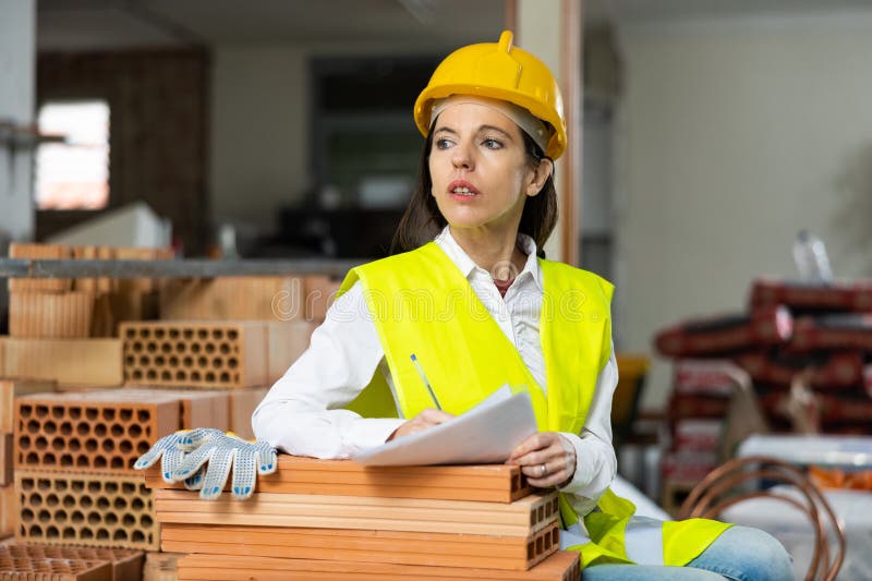 Female Civil Engineer Making Notes while Controlling Workflow at ...