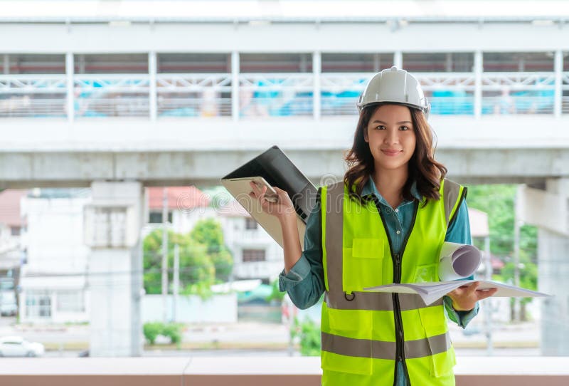 Female Civil Engineer with Safety Equipment with Sunset City Golden Sky ...