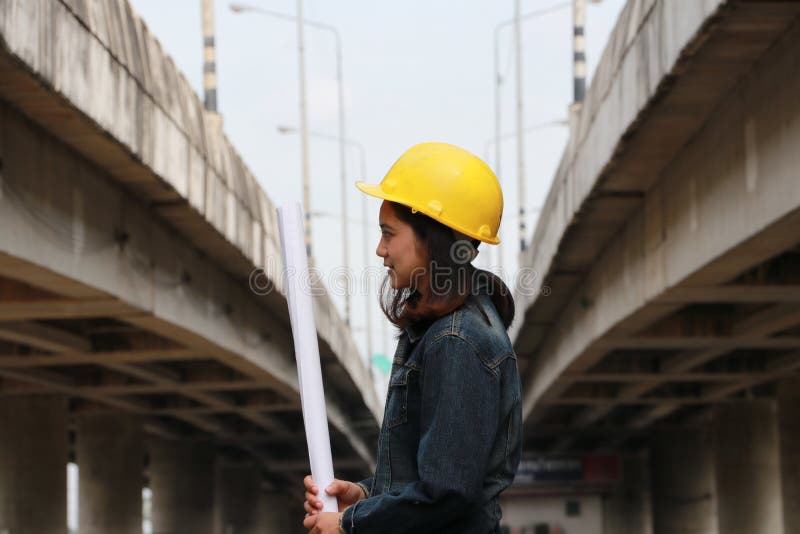Female Civil Engineer with Yellow Helmet, Standing Side To Side with ...