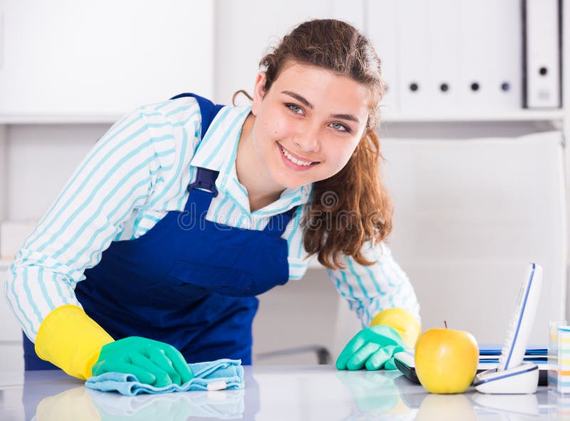 Female Cleaner is Cleaning Dust from the Desk Stock Photo - Image of ...
