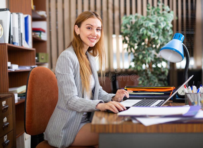 Female Clerical Worker Sitting at Desk in Office Stock Photo - Image of ...