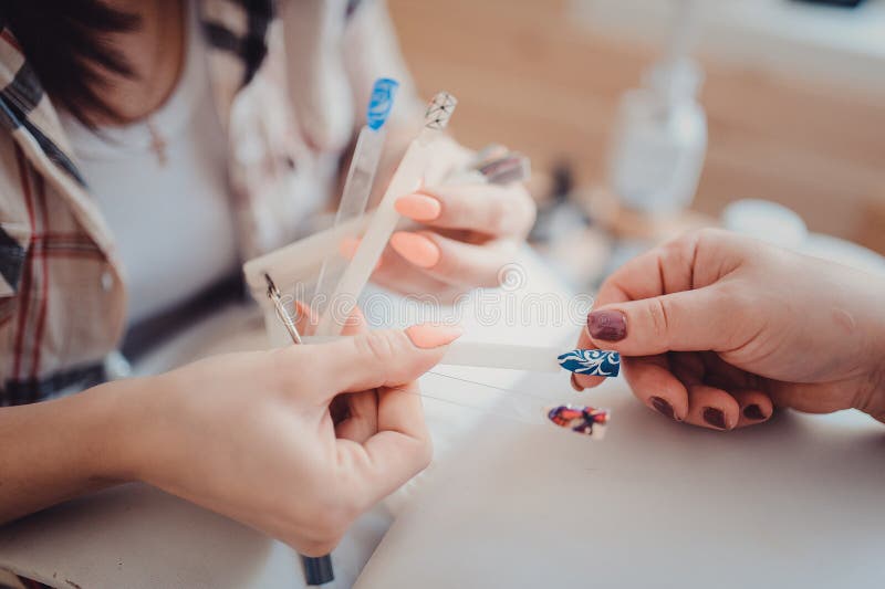 Female Client during Gel Manicure with Manicurist Displaying Samples of ...
