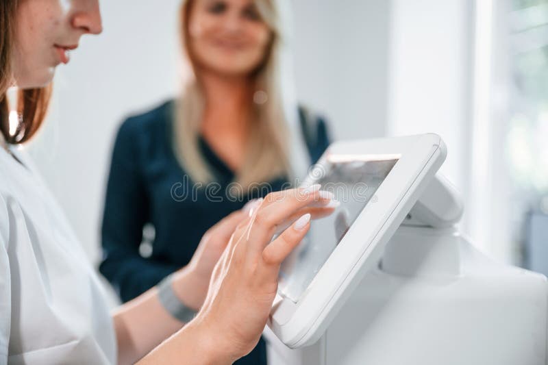 Female Clinic Worker Setting Up Special Device for Vision Test. Female ...
