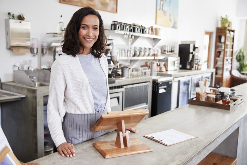 Female Coffee Shop Owner Standing Smiling Behind the Counter Stock ...