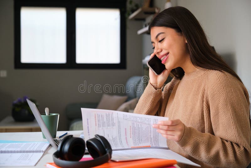 Female College Student with Braces Talking on the Phone while Study at ...