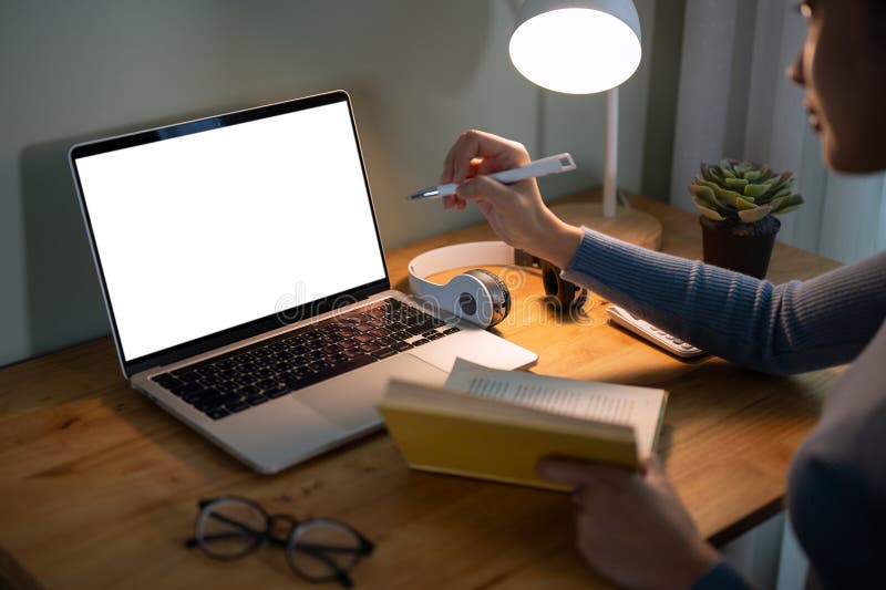 A Female College Student is Doing Her Homework at a Table in Her Room ...