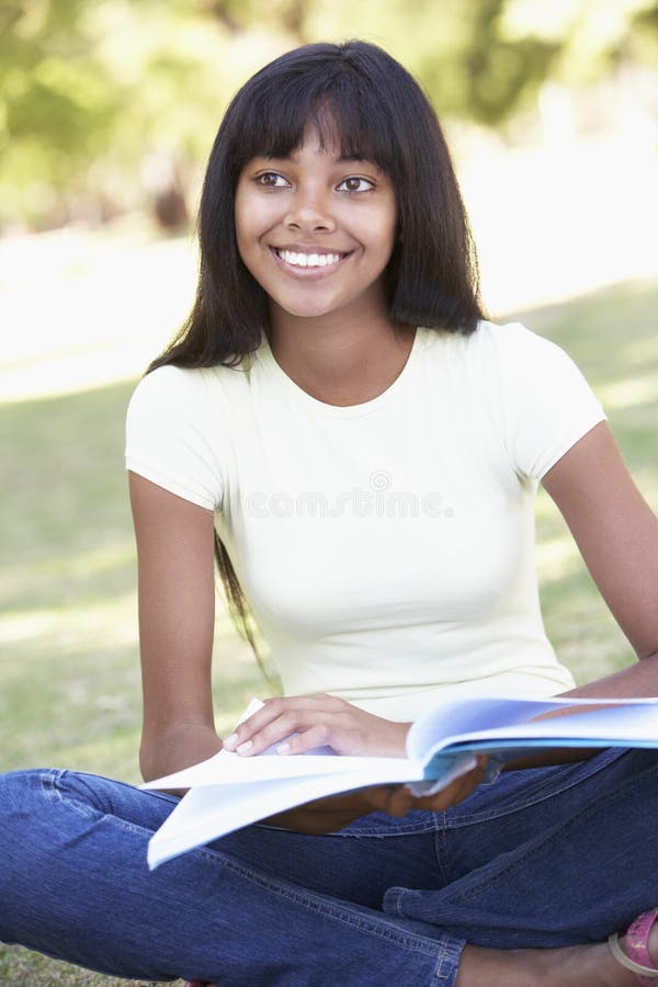 Female College Student Sitting in Park Reading Textbook Stock Image ...