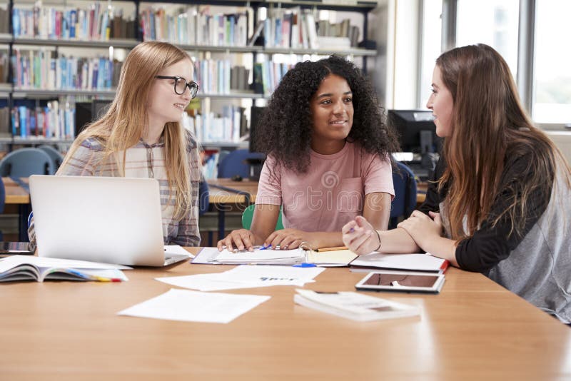 Female College Students Working in Library Together Stock Photo - Image ...