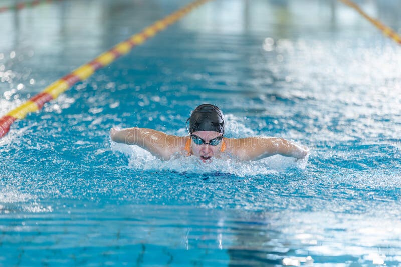 Female Swimmer Moving through the Water Performs a Butterfly Stroke ...