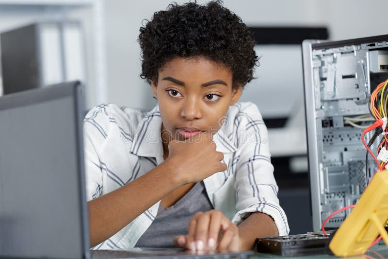 Female Computer Technician Looking at Laptop Stock Image - Image of ...