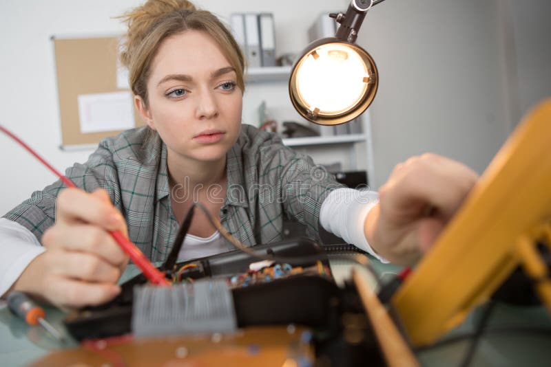 Female Computer Technician Using Multimeter Stock Image - Image of ...