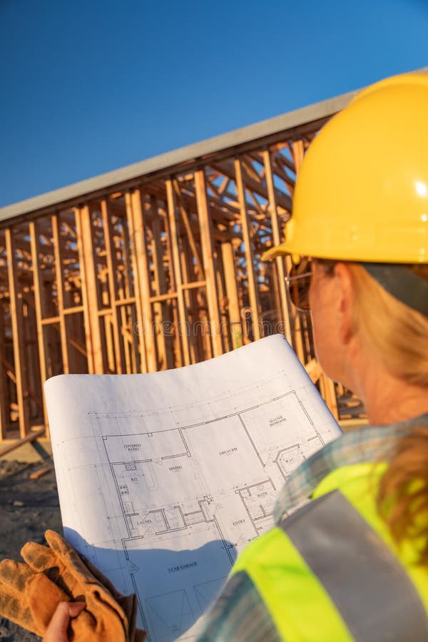 Female Construction Worker with House Plans at Construction Site Stock ...