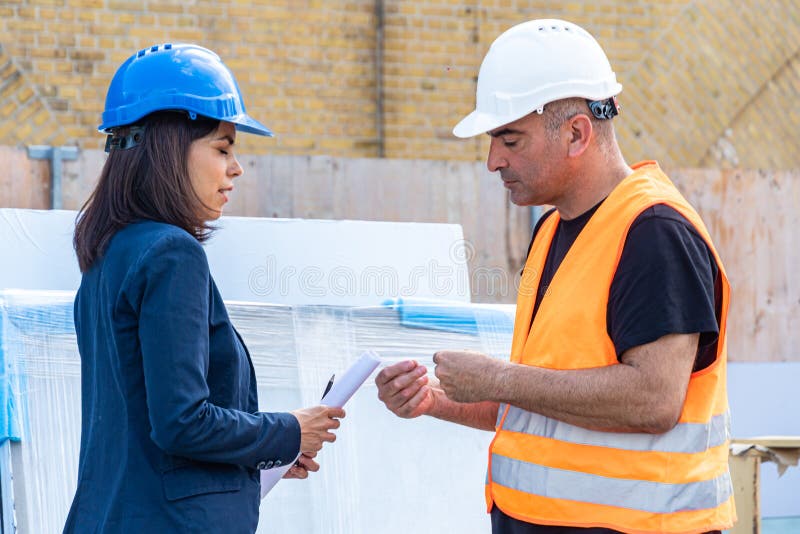 Female Construction Boss Talking To a Foreman Stock Photo - Image of ...
