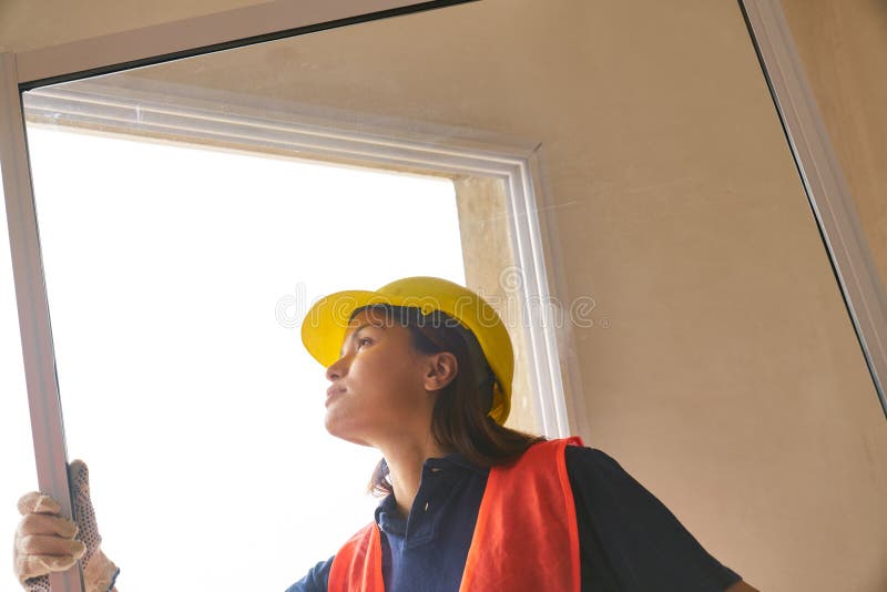 Young Female Construction Worker Wearing Safety Hardhat Installing ...