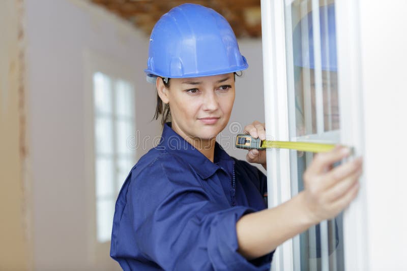 Female Construction Worker Measuring Windows Stock Image - Image of ...