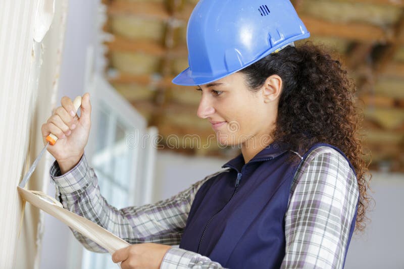 Female Construction Worker Removing Wallpaper with Scraper Stock Image ...