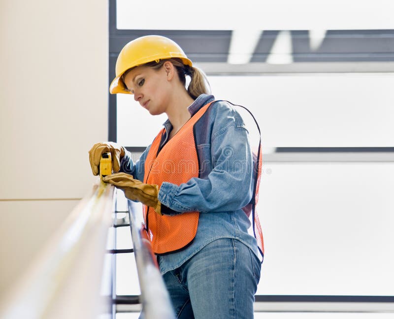Female Construction Worker Taking Measurement Stock Photo - Image of ...