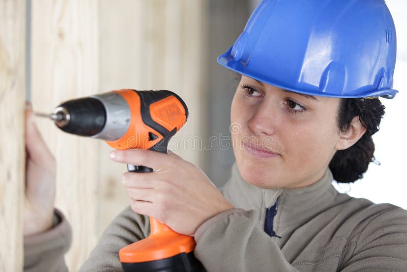 Female Construction Worker Using Cordless Drill Stock Image - Image of ...