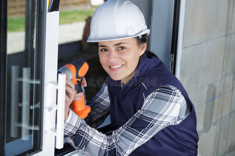 Female Construction Worker Using Power Tool on Window Stock Photo ...