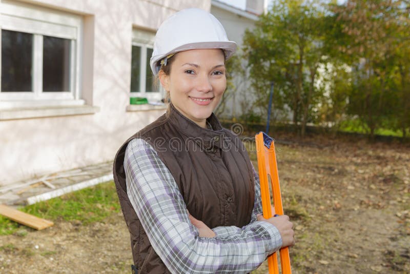 Female Constructor Working with Level Outdoors Stock Photo - Image of ...