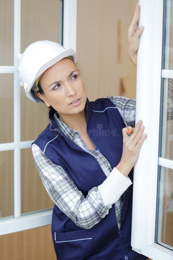 Female Contractor Adjusting Window Stock Photo - Image of installation ...