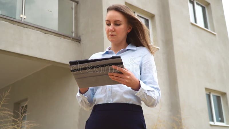 Female Contractor in Front of New Building Construction. Stock Footage ...