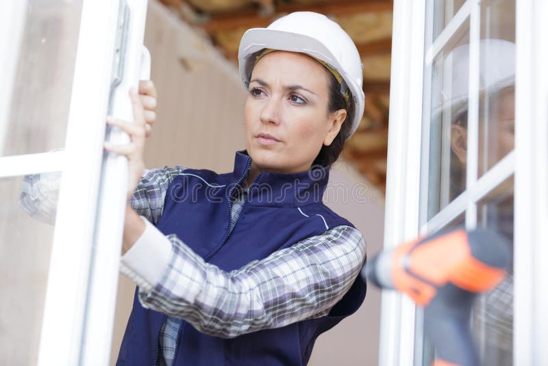 Female Contractor Installing Windows Stock Photo - Image of work, woman ...