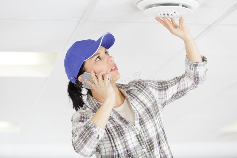Female Contractor on Phone Checking Ceiling Stock Image - Image of ...