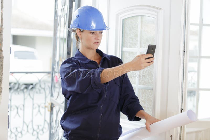 Female Contractor Taking Picture Inside Stock Photo - Image of friendly ...